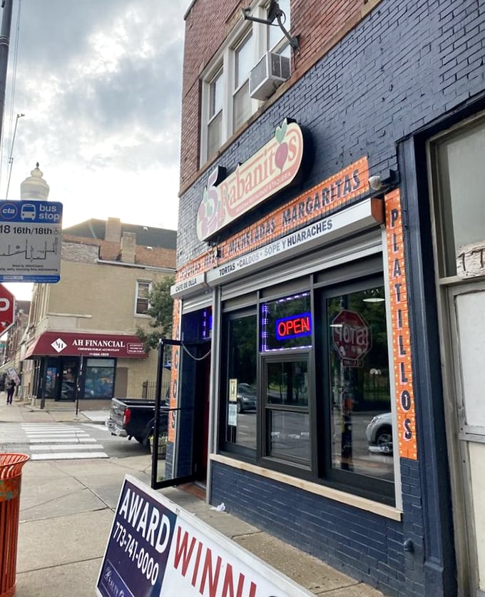 The blue facade of 5 Rabanitos stands out on 18th Street like a delicious beacon, promising authentic Mexican flavors behind that neon "OPEN" sign.