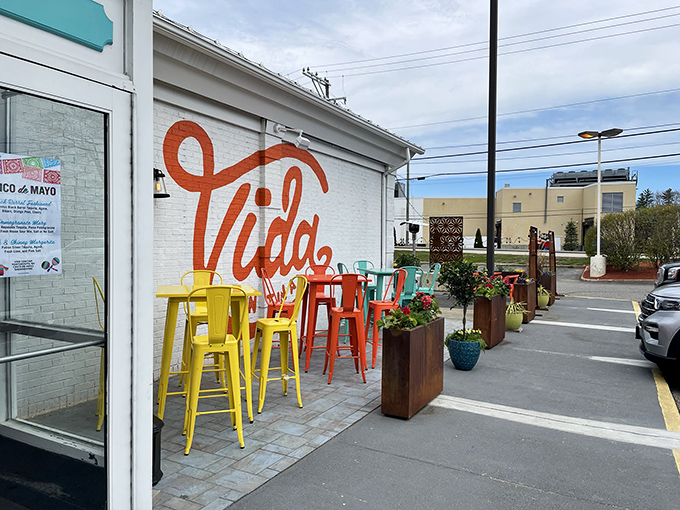 The unassuming exterior hides a culinary fiesta within&mdash;like finding a perfect beach behind an ordinary door, Vida Cantina's vibrant orange script promises adventure.