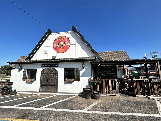 The charming A-frame exterior with its welcoming red umbrellas feels like discovering a secret portal to Mexico right in Oklahoma City.