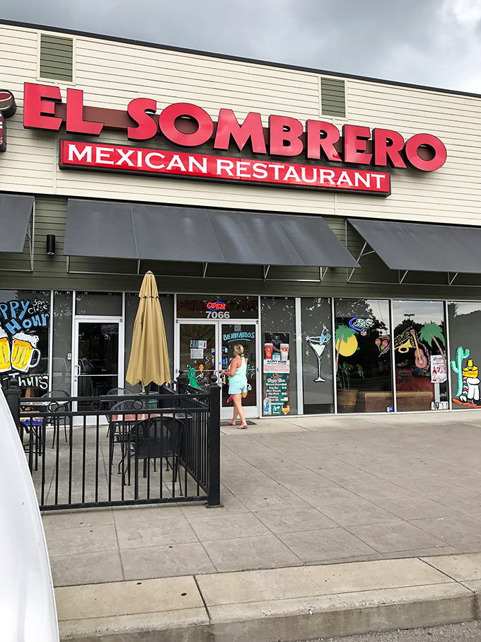 The unassuming brick exterior of El Sombrero belies the culinary treasures within. Red signage and a simple "OPEN" sign invite curious diners to discover Franklin's hidden Mexican gem. 