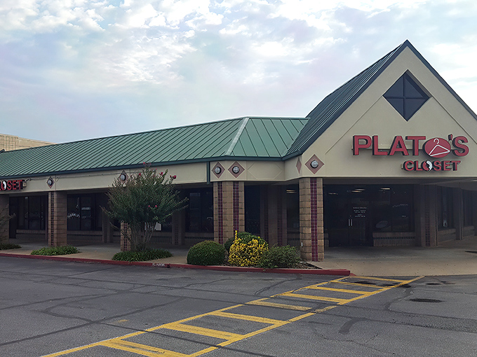The distinctive green-roofed exterior of Plato's Closet in Fayetteville welcomes fashion hunters with the promise of treasures within.