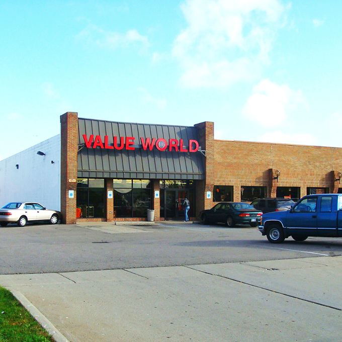 The brick facade of Value World stands proudly against a blue Michigan sky, like a fortress guarding treasures waiting to be discovered.