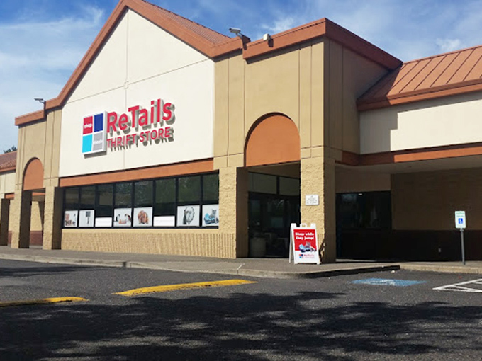 A rainbow arches over ReTails Thrift Store like nature's own "Grand Opening" banner, promising treasures at the end of your bargain-hunting journey.