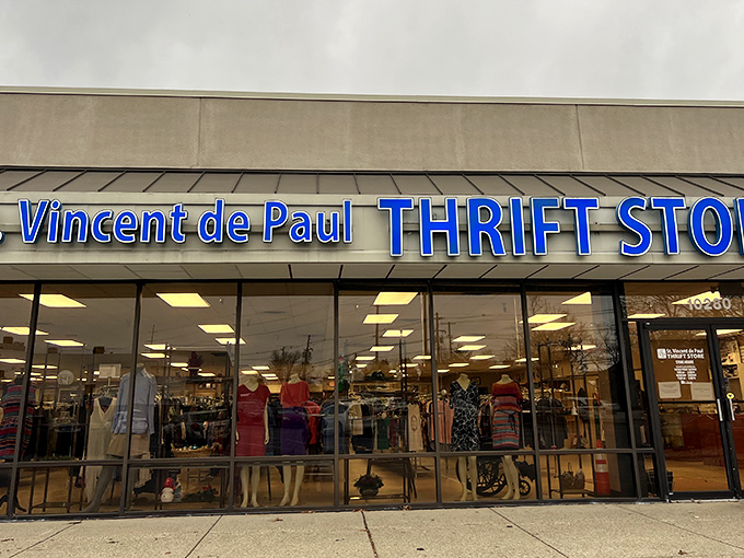 The blue signage of St. Vincent de Paul beckons like a thrift store lighthouse, promising treasures within those glass doors.