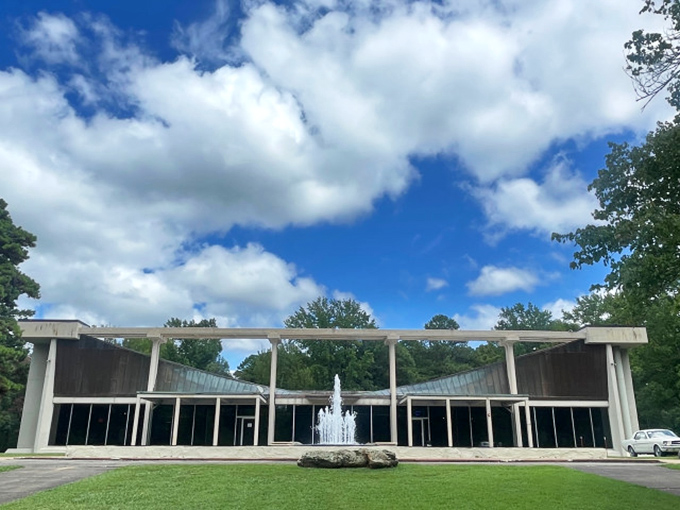 The modernist architecture of the Museum of Automobiles stands like a mid-century time capsule against Arkansas's lush greenery, complete with a welcoming fountain.