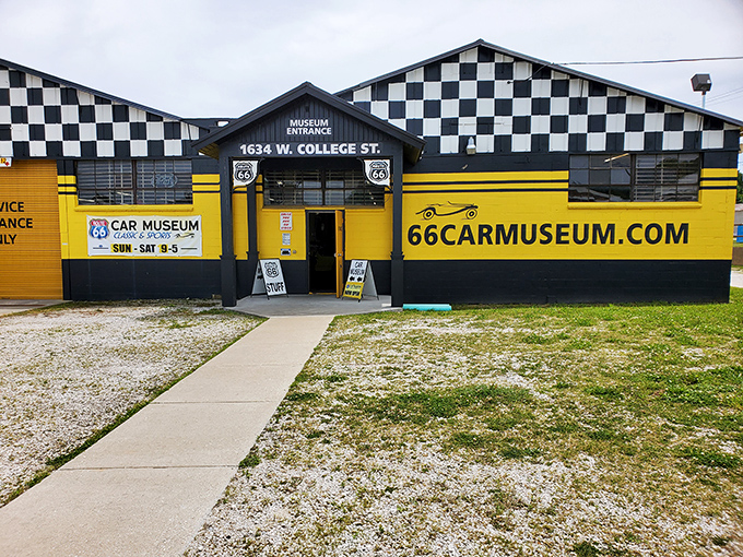 The classic checkered flag meets sunshine yellow on this roadside gem. A fitting beacon for automotive aficionados traveling along the Mother Road.