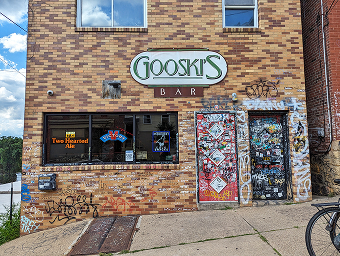 The iconic brick façade of Gooski's looks like the gatekeeper of Pittsburgh's underground music scene, complete with generations of sticker graffiti chronicling its storied history.