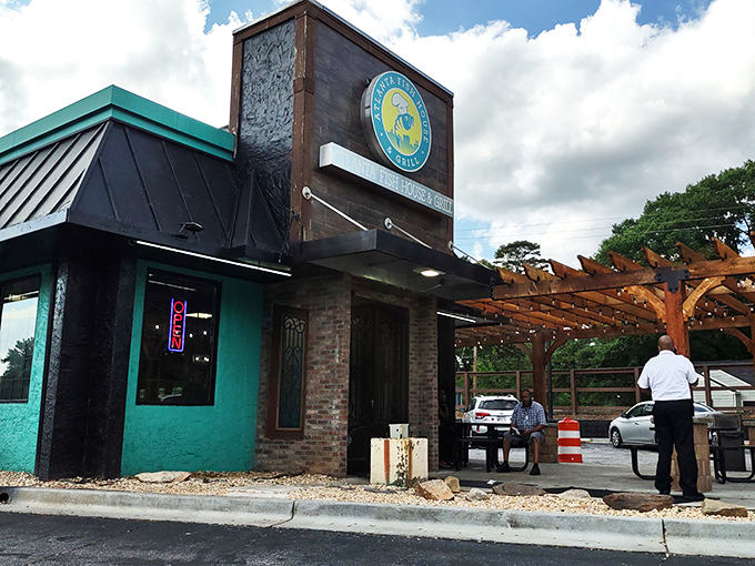The teal and stone exterior beckons like a seafood lighthouse in Atlanta's urban landscape. That wooden pergola practically whispers "come sit awhile."