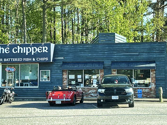 The blue facade of The Chipper stands like a beacon of British comfort food amid Virginia greenery, promising authentic fish and chips to weary travelers.