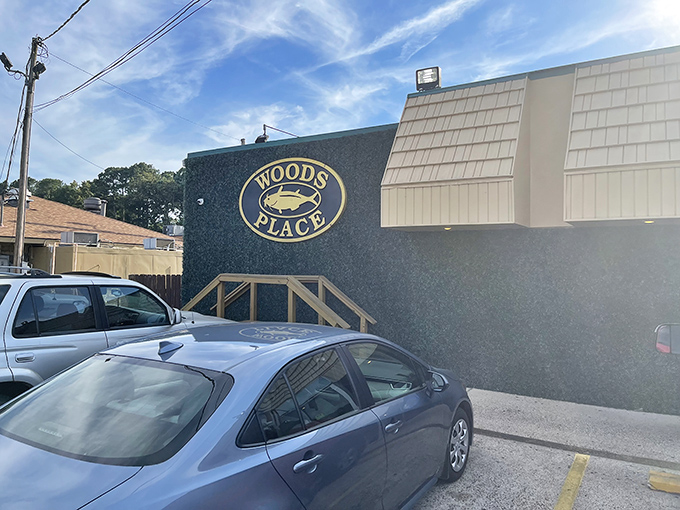 The unassuming exterior of Woods Place, with its distinctive green trim and simple sign, stands as Camden's culinary beacon for catfish aficionados.