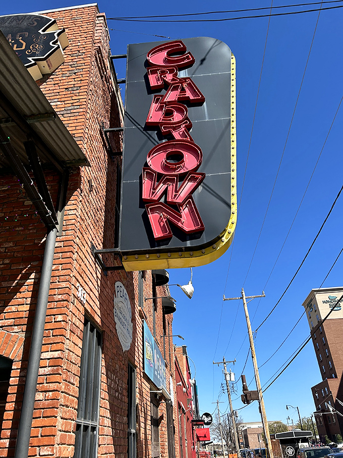 The iconic red neon "CRATOWN" sign beckons hungry travelers like a lighthouse for landlocked seafood lovers in Oklahoma City's Bricktown district.