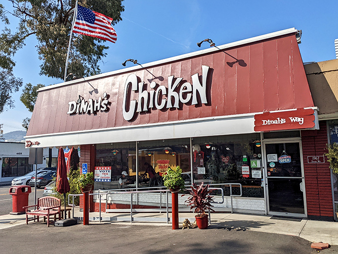 The iconic red roof of Dinah's Chicken stands like a beacon of comfort food salvation in Glendale, complete with an American flag that seems to salute your good taste.