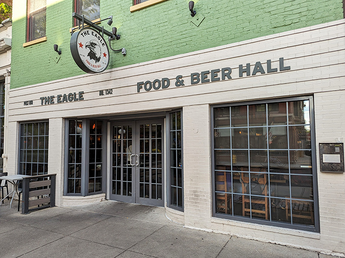 The mint-green facade of The Eagle OTR stands like a beacon of culinary promise in Cincinnati's historic district, its unassuming exterior hiding delicious secrets within.