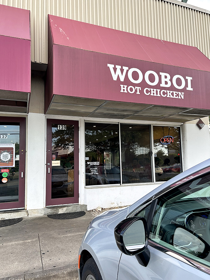 The burgundy awning beckons like a siren song to heat-seekers. WOOBOI's unassuming strip mall location hides culinary fire within.