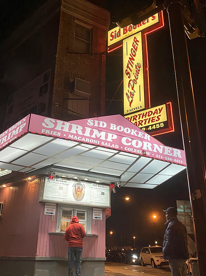 The neon-pink beacon of Sid Booker's illuminates the Philadelphia night like a seafood lighthouse, calling hungry travelers home to shrimp paradise.