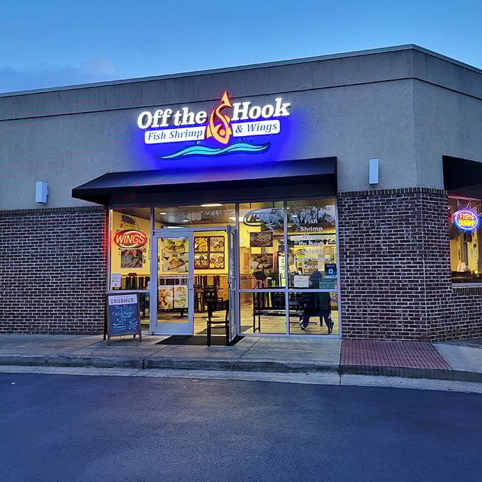 The neon glow of Off The Hook beckons like a lighthouse for the seafood-starved, promising fried treasures within its unassuming brick walls.