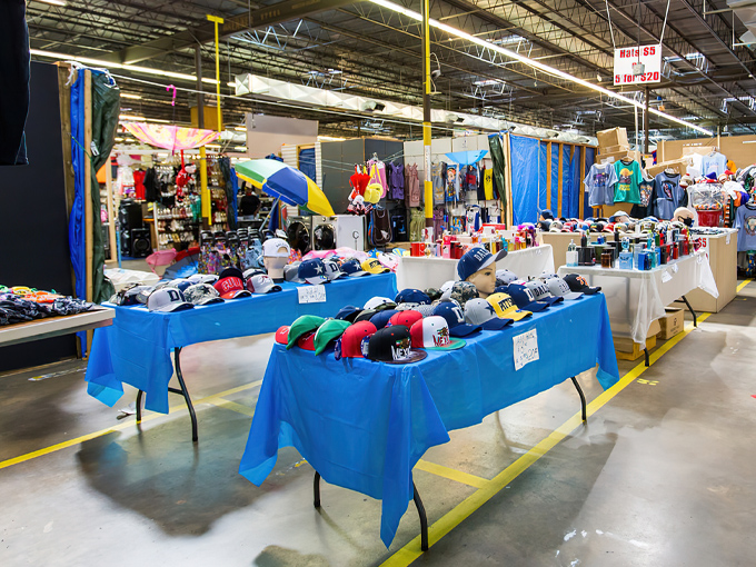 Tables draped in blue showcase a rainbow of baseball caps – the unofficial uniform of weekend warriors and bargain hunters alike.