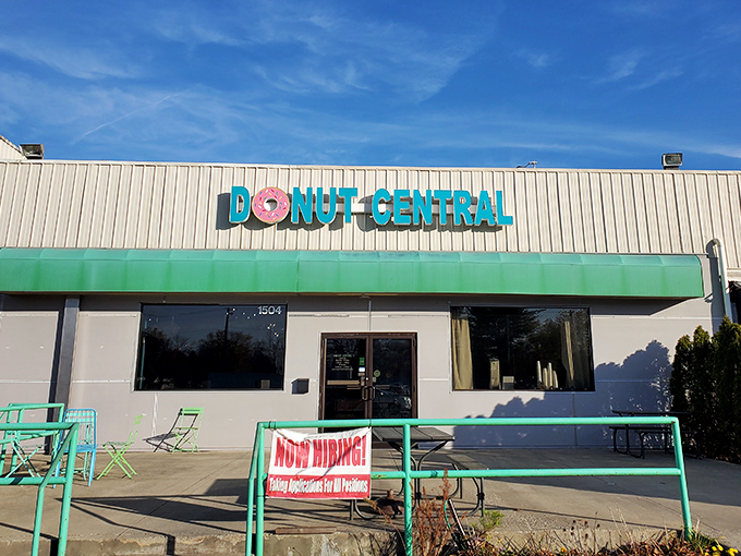 The teal and pink sign beckons like a sugar-coated lighthouse on the Columbus horizon. Donut Central's exterior promises sweet adventures within.