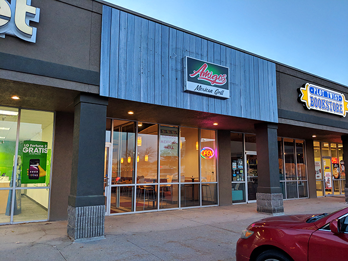 The bright yellow "AMIGOS" sign beckons like a lighthouse for hungry souls. No fancy frills, just the promise of authentic Mexican goodness waiting inside.