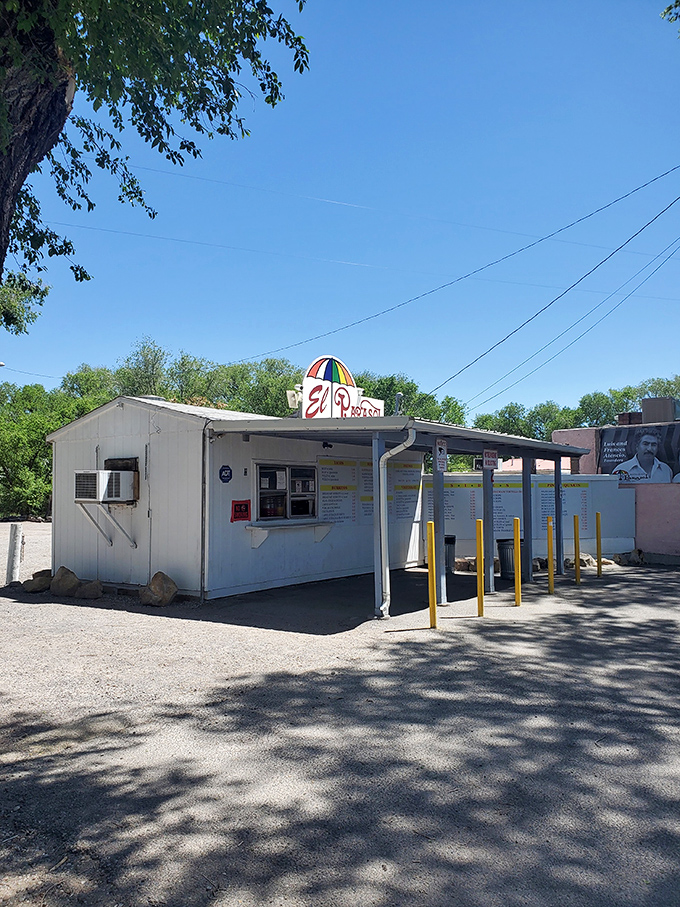 The humble roadside stand with its cheerful umbrella logo promises more flavor per square foot than establishments ten times its size.