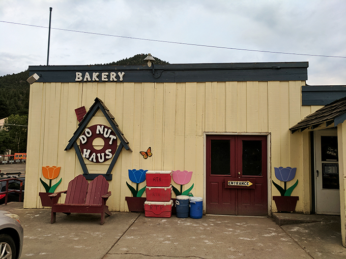 The unassuming exterior of Donut Haus stands like a beacon of sugary hope against the majestic Rocky Mountain backdrop. Sweet treasures await inside.