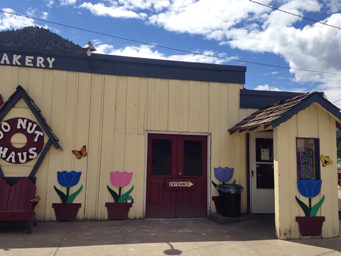 The unassuming exterior of Donut Haus stands like a beacon of sugary hope against the majestic Rocky Mountain backdrop. Sweet treasures await inside.