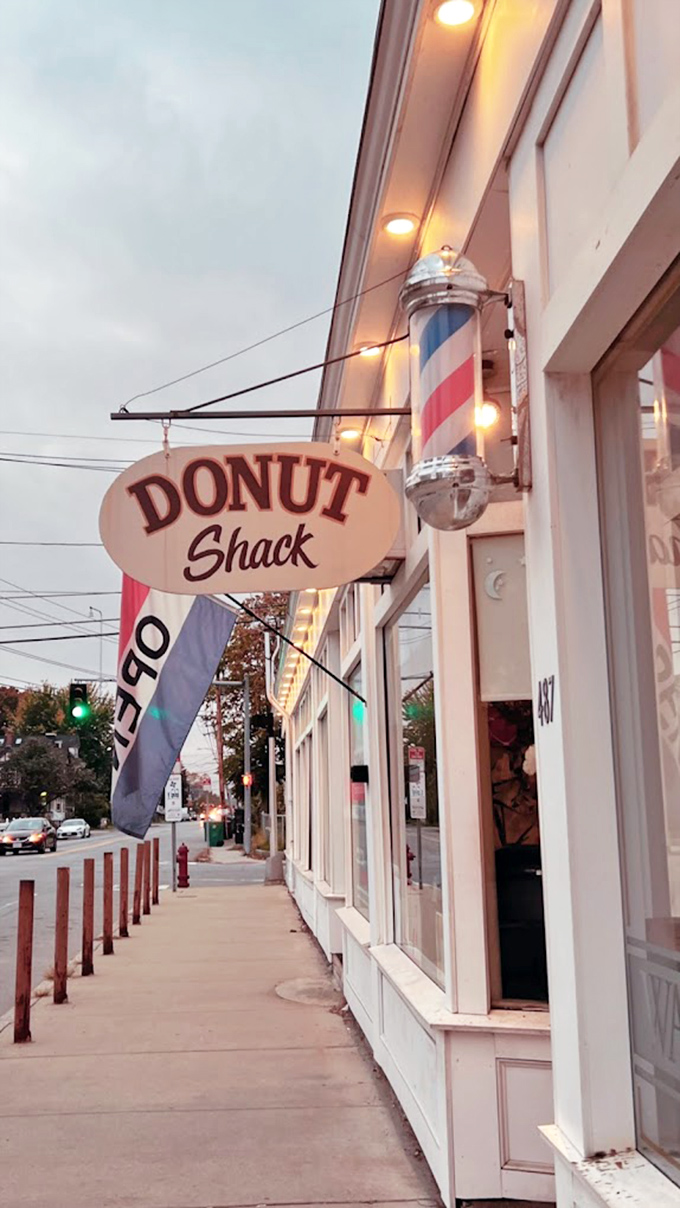 The classic barber pole and vintage sign beckon like an old friend. This modest storefront in Lowell hides donut treasures better than any fancy bakery could dream of.