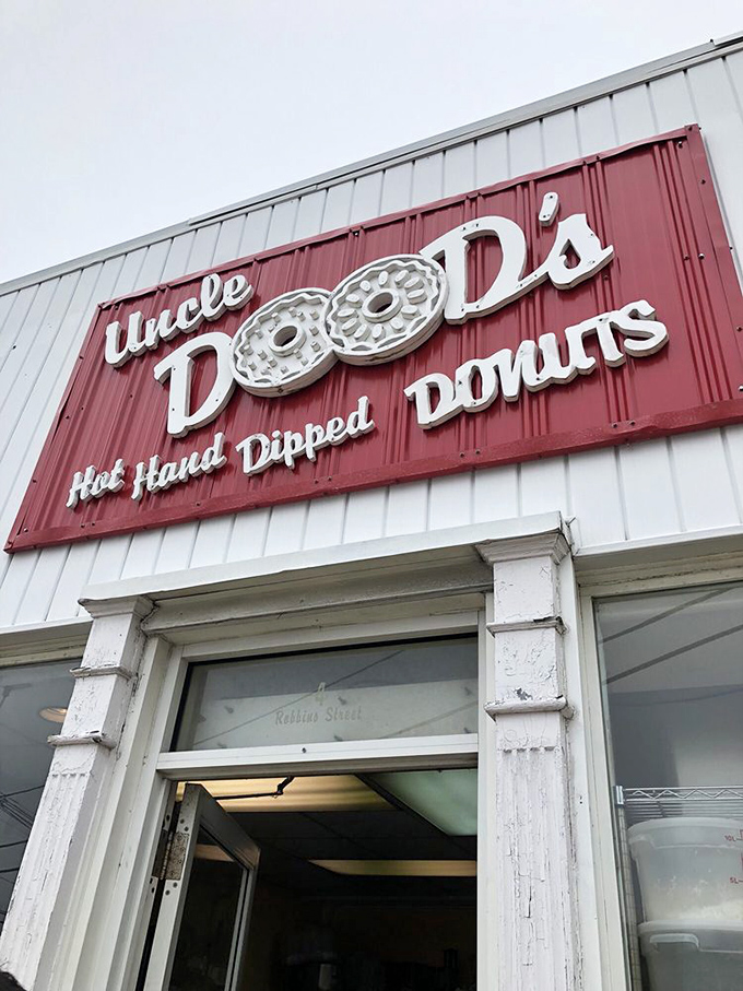The iconic red and white sign promises "Hot. Hand. Dipped. Donuts." &mdash; four words that might be the sweetest poetry ever written on a storefront.