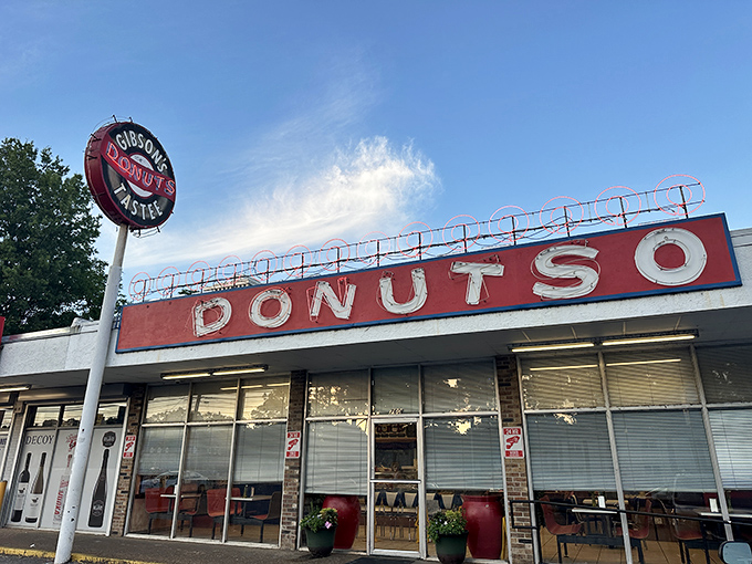 The iconic Gibson's Donuts storefront stands proudly against Memphis' skyline, a beacon of fried dough perfection for early risers and night owls alike.