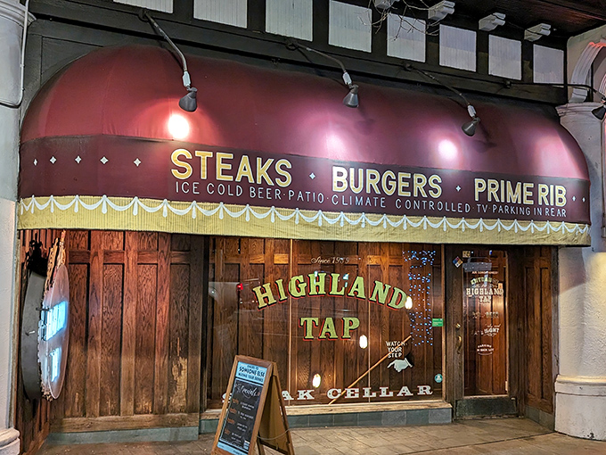 The entrance to Highland Tap beckons like a speakeasy from another era. Stone walls and that iconic burgundy awning promise carnivorous delights below street level.
