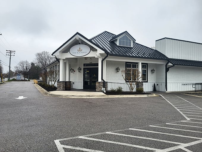 The farmhouse-chic exterior of Blackwall Barn & Lodge stands like a culinary lighthouse in Gambrills, beckoning hungry travelers with its pristine white siding and elegant black roof.