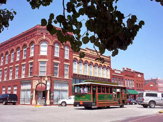 Guthrie's Victorian storefronts stand proudly like architectural time travelers. That mint-green Daylight Donuts sign promises sweet rewards for early risers. 