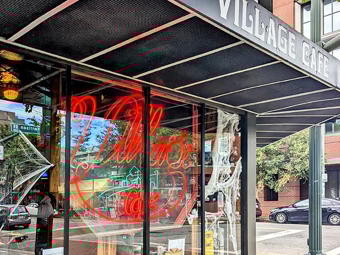 That iconic neon sign beckons like an old friend through the window. Village Cafe's exterior promises authentic diner magic without a hint of pretension.