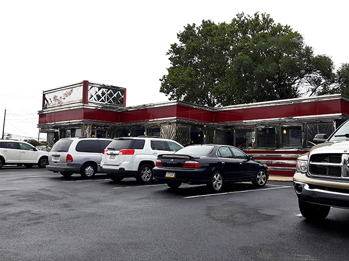 The classic roadside silhouette of Route 61 Diner stands against an autumn sky, beckoning hungry travelers like a neon-lit lighthouse for the famished. 