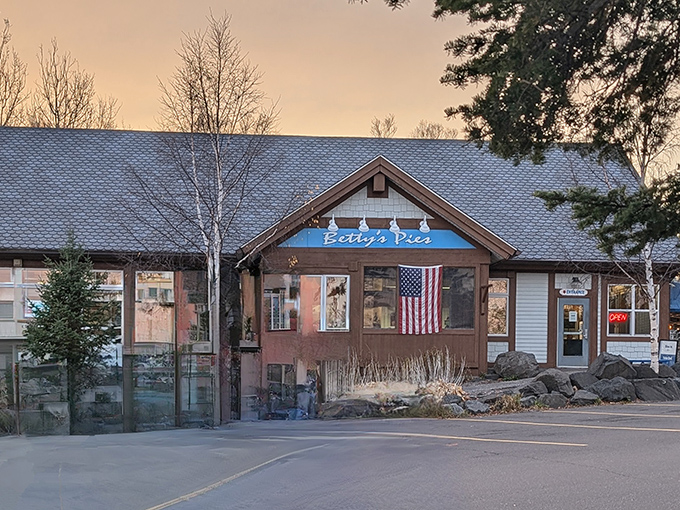 Betty's Pies stands like a North Shore sentinel, its blue sign and American flag promising comfort and sweetness to weary travelers.