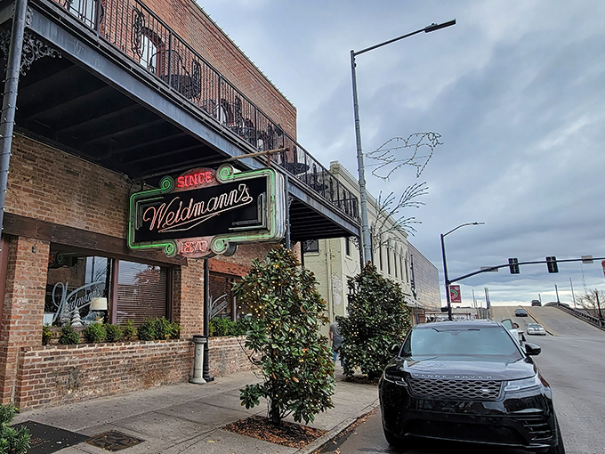 The iconic neon sign of Weidmann's glows like a beacon of culinary hope on a downtown Meridian street. Southern hospitality awaits just beyond those doors.