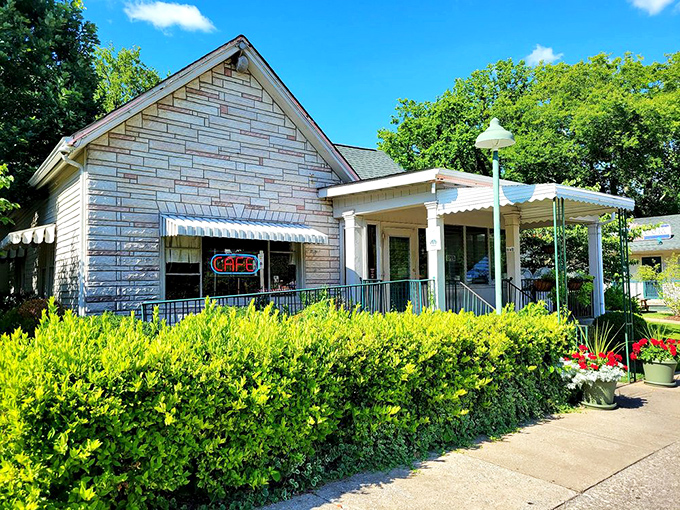 The white clapboard exterior of Loveless Cafe stands like a time capsule of Southern hospitality, complete with seasonal flower barrels and that iconic neon sign.