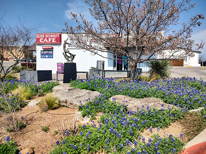 The unassuming exterior of Blue Bonnet Cafe stands like a beacon of hope for hungry travelers. Texas sunshine and pie await.