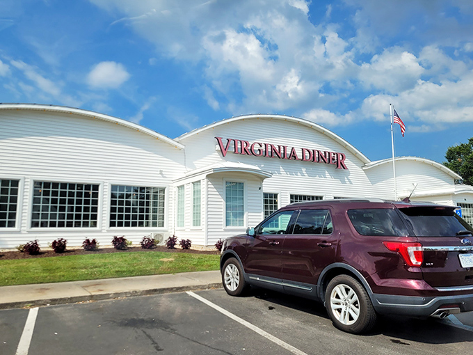 The iconic white exterior of Virginia Diner stands proudly against blue skies, a beacon of comfort food that's been welcoming hungry travelers since 1929.