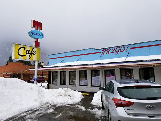 The iconic blue and yellow Twede's Cafe sign stands tall against the Washington sky, beckoning hungry travelers with promises of pie-fueled happiness.