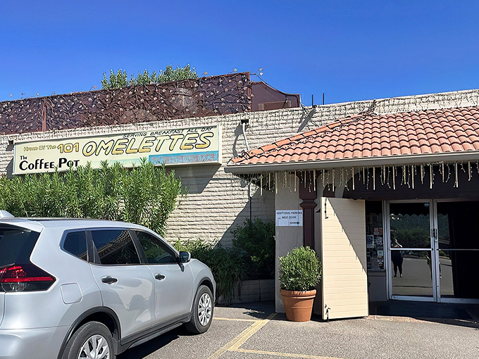 The red-roofed sanctuary of breakfast dreams stands proudly against Sedona's iconic red rocks, promising morning salvation for hungry travelers.