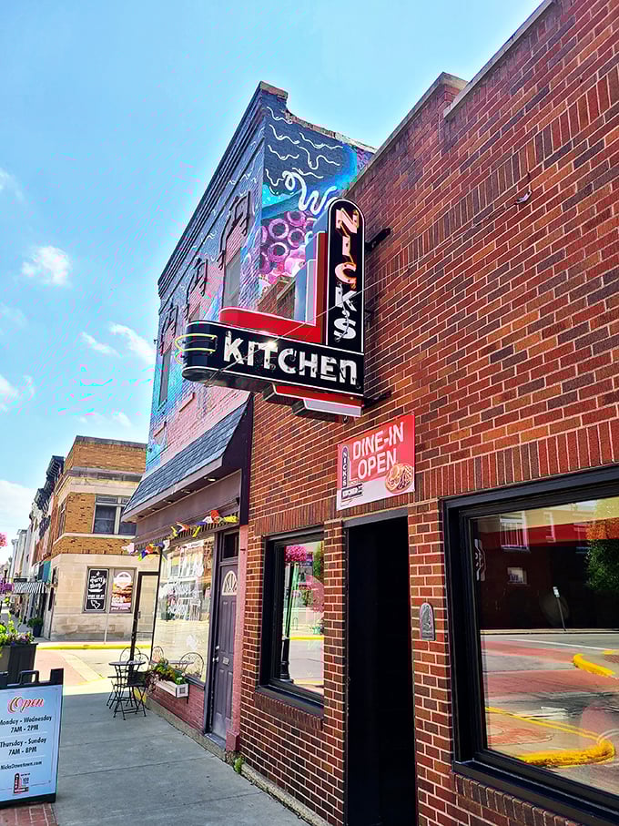 The iconic neon sign of Nick's Kitchen stands as a beacon of culinary history on Huntington's Jefferson Street. A century of tenderloin tradition lives behind this brick fa&ccedil;ade.