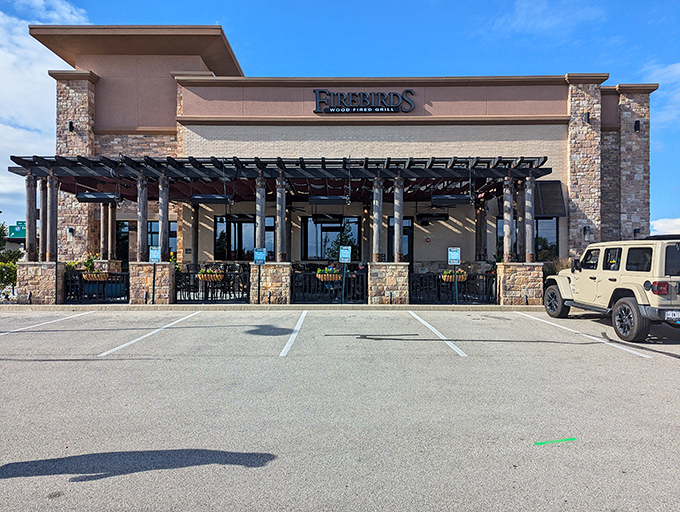 Modern meets rustic at Firebirds' exterior, where stone pillars and contemporary architecture promise a dining experience beyond the ordinary.