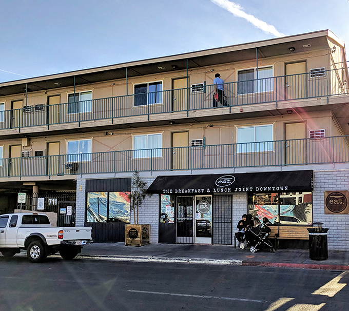 A modest storefront with a wooden bench that whispers, "The best culinary experiences often hide behind the simplest facades." Downtown Las Vegas's best-kept breakfast secret awaits.