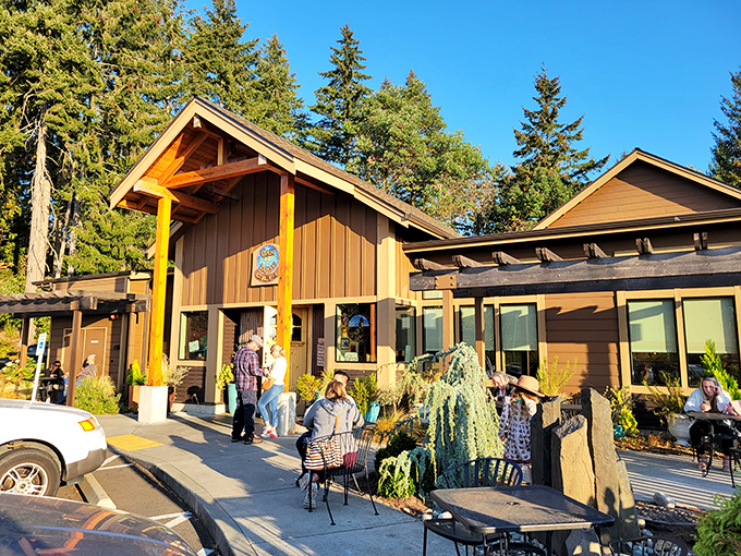 The Oak Table Cafe stands like a woodland retreat among Silverdale's evergreens, promising pancake paradise behind those timber beams.
