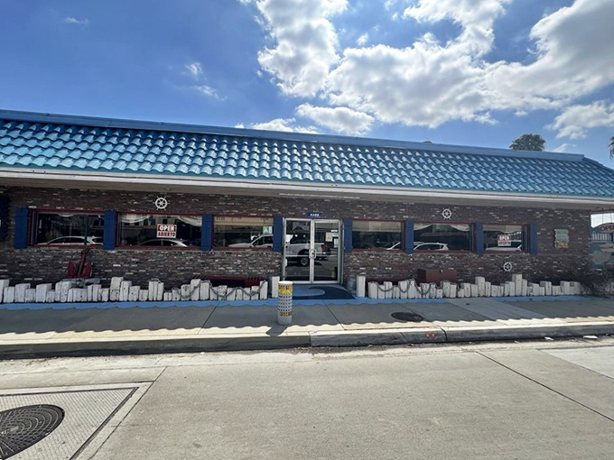 The turquoise roof of Shrimp House stands out like a maritime beacon in suburban Arcadia, promising seafood treasures within its humble brick walls.
