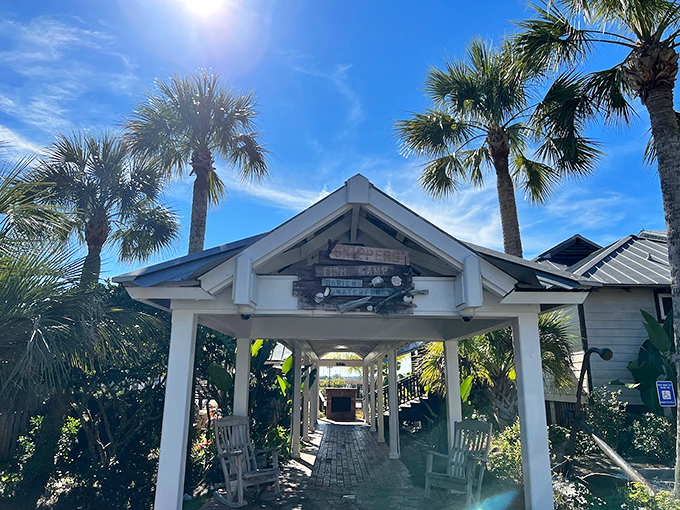 The welcoming pavilion entrance to Skippers Fish Camp beckons like a coastal siren song, promising seafood treasures just beyond those white columns.