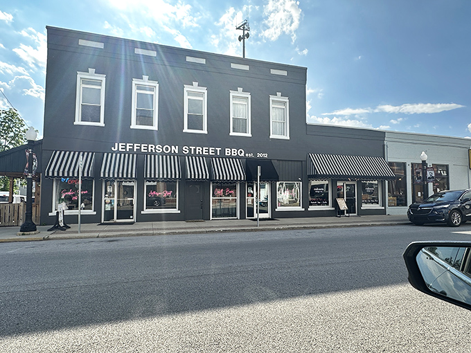 The classic black exterior with striped awnings isn't just charming&mdash;it's a beacon calling to barbecue pilgrims from across Indiana. Small-town magic with big-time flavor.