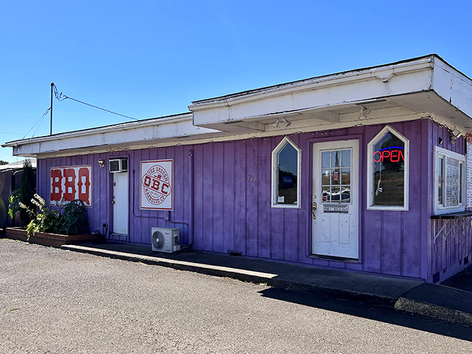 The unmistakable purple exterior of Oregon Barbecue Company stands out like a beacon for hungry travelers, promising smoky delights within.
