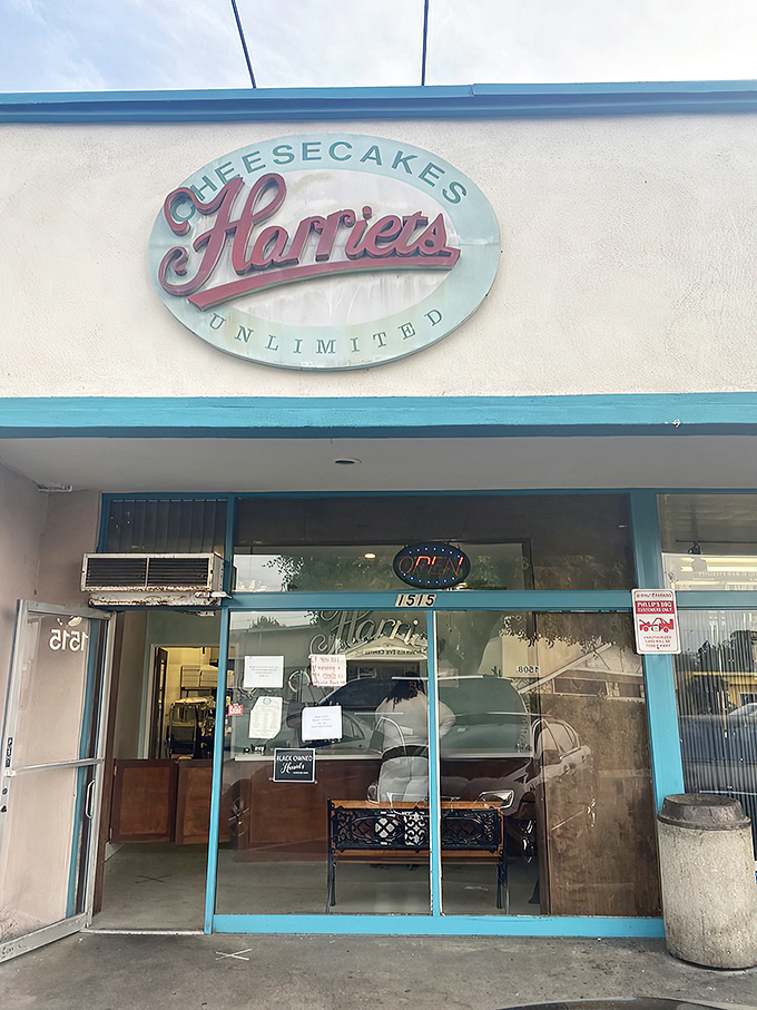 The unassuming storefront of Harriet's Cheesecakes Unlimited in Inglewood &ndash; proof that culinary greatness often hides in plain sight behind modest blue trim.